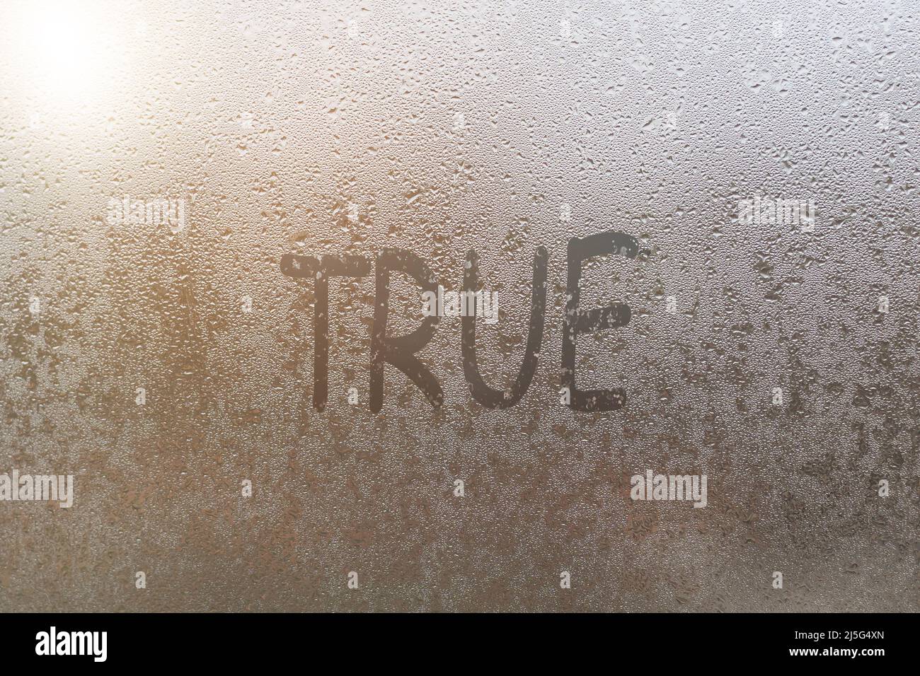 Foggy glass on window with written finger word true Stock Photo - Alamy