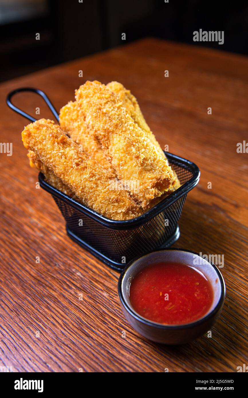 breaded cheese sticks with sauce on the table Stock Photo - Alamy