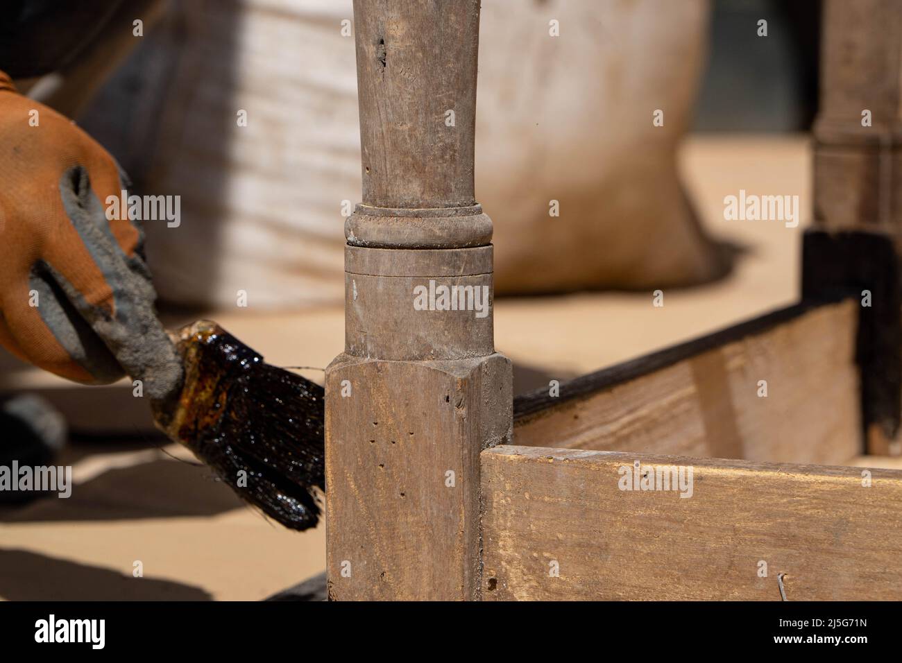 Man working on old forniture restoration using bitumen judaicum. Wood ...