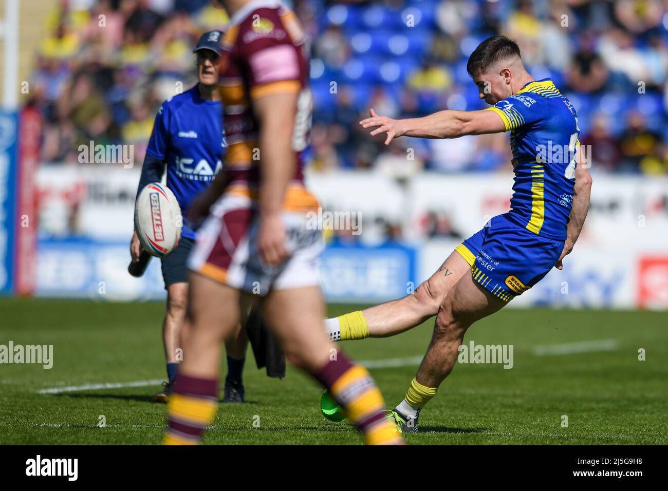 Riley Dean #27 of Warrington Wolves kicks a penalty to make it 18-0 ...