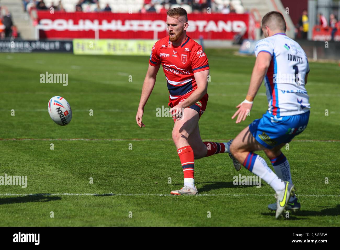 Rowan Milnes #21 of Hull KR puts a kick through the Wakefield defence ...
