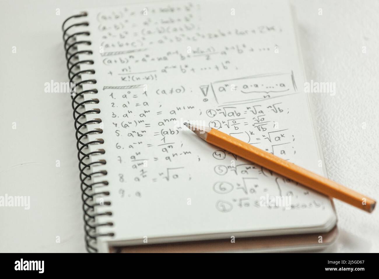 Math formulas are written in pencil on a piece of paper, math problems ...
