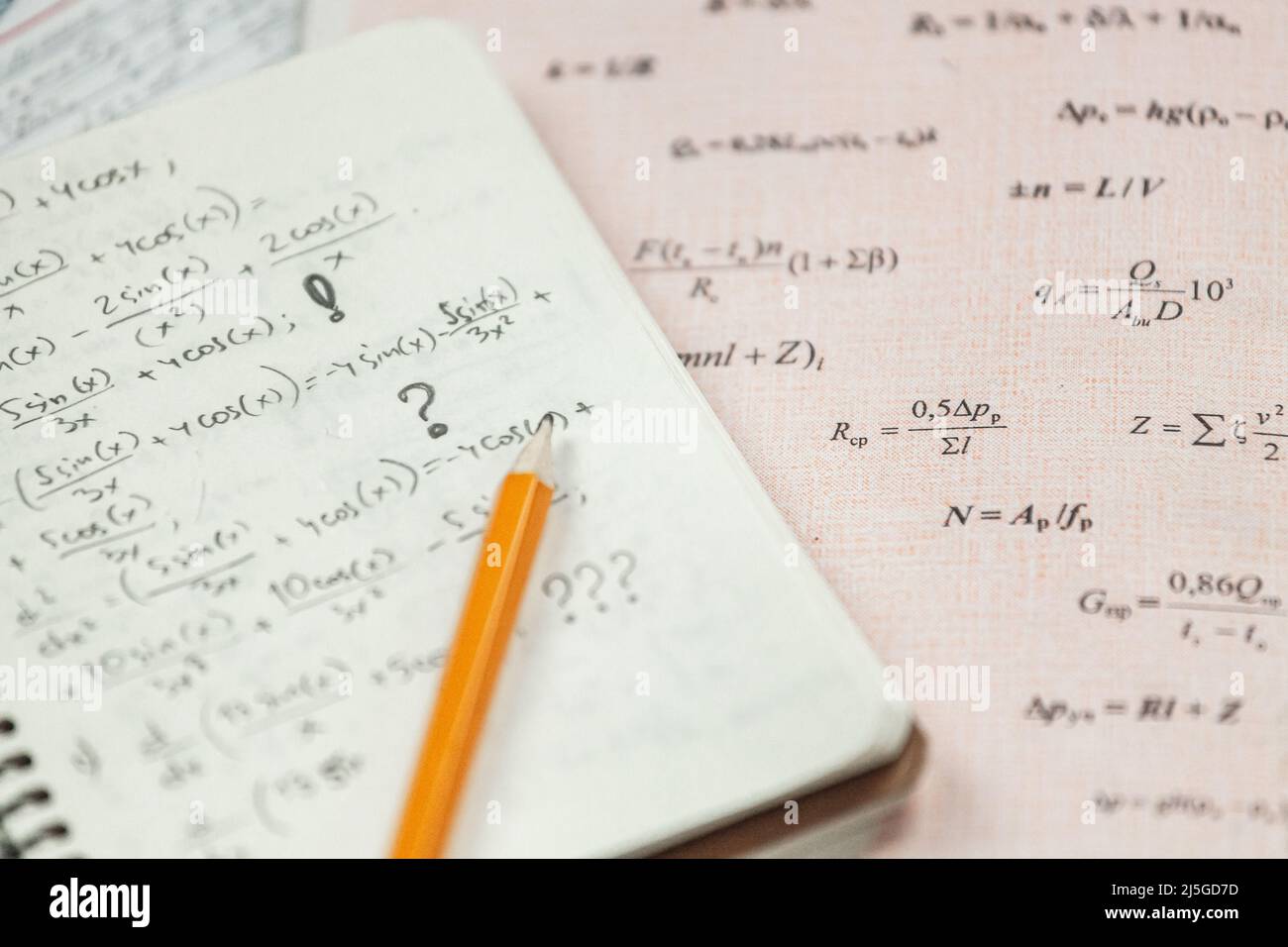 Math formulas are written in pencil on a piece of paper, math problems ...
