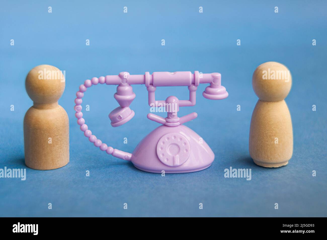 Traditional analog phone with wooden dolls. Communication and copy ...