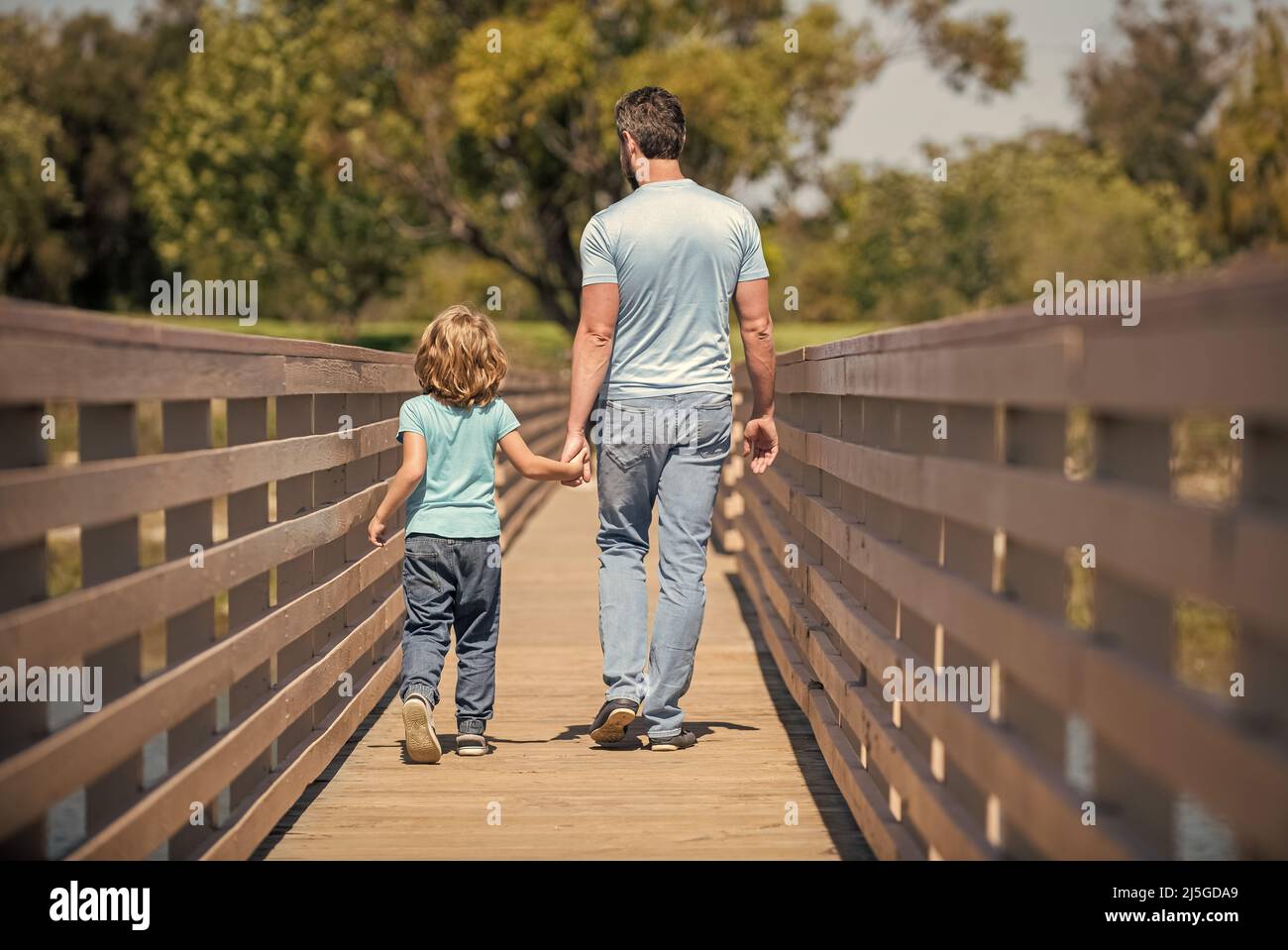 fathers day. father and son walking outdoor back view. family value ...