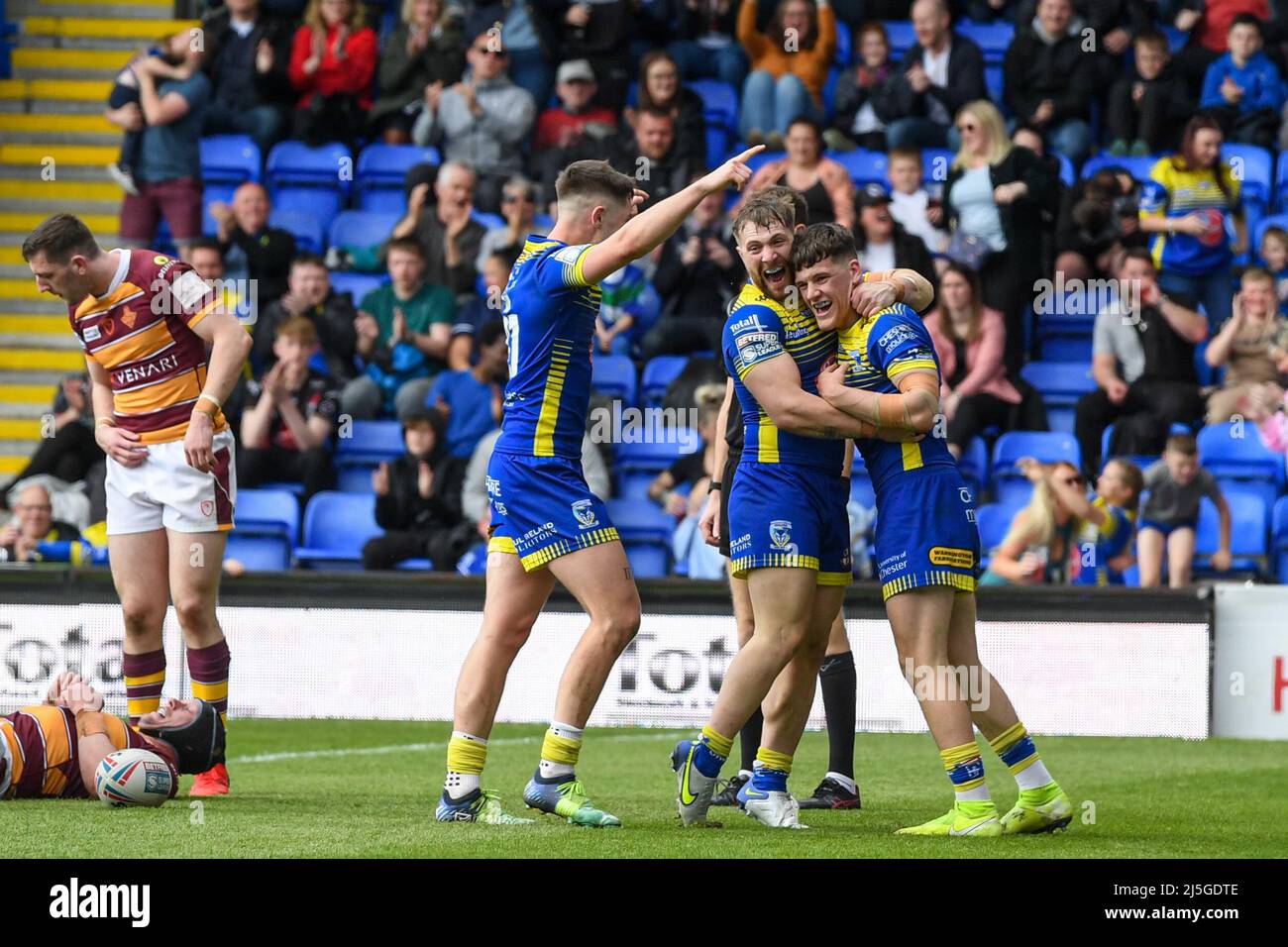 Josh Thewlis #22 of Warrington Wolves celebrates scoring a try to make ...