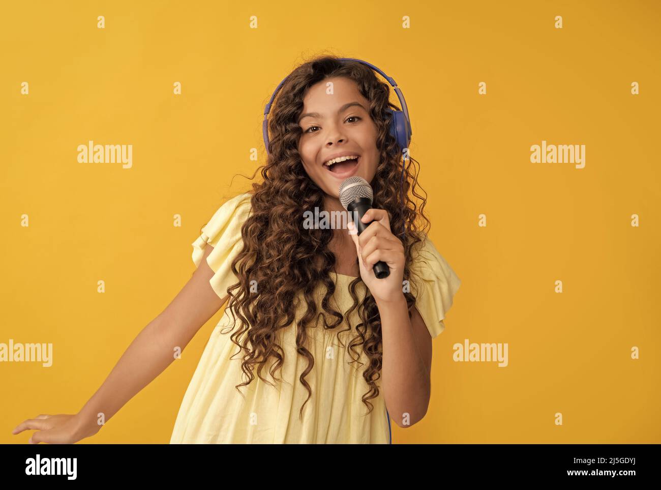 child singer sing karaoke in microphone. online vocal education. back ...