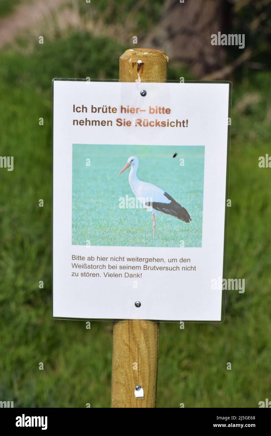 stork nest warning sign at a dirt road, don't approach the nest Stock ...