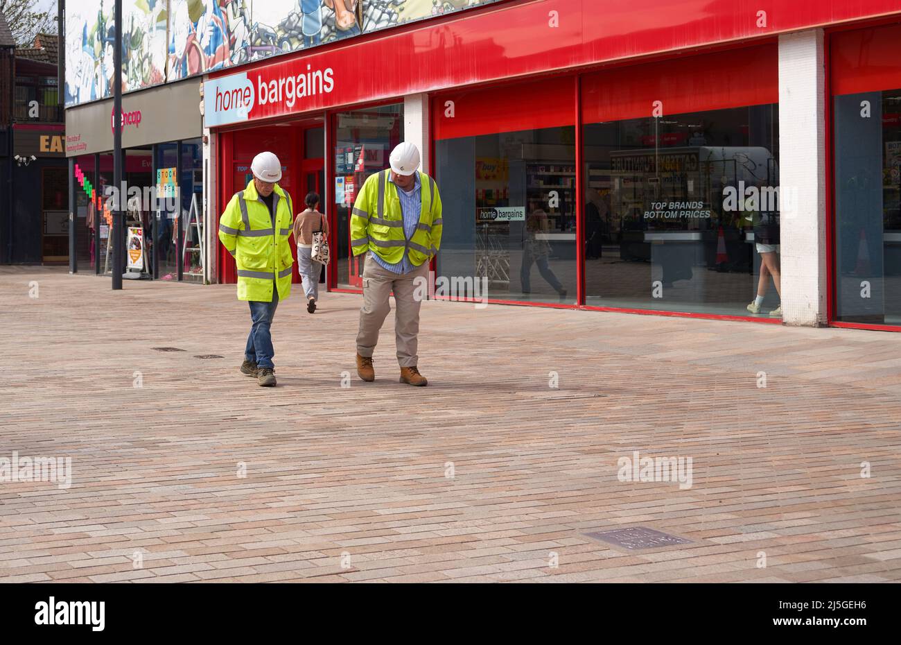 Two workmen inspecting new block paving in a town center Stock Photo ...