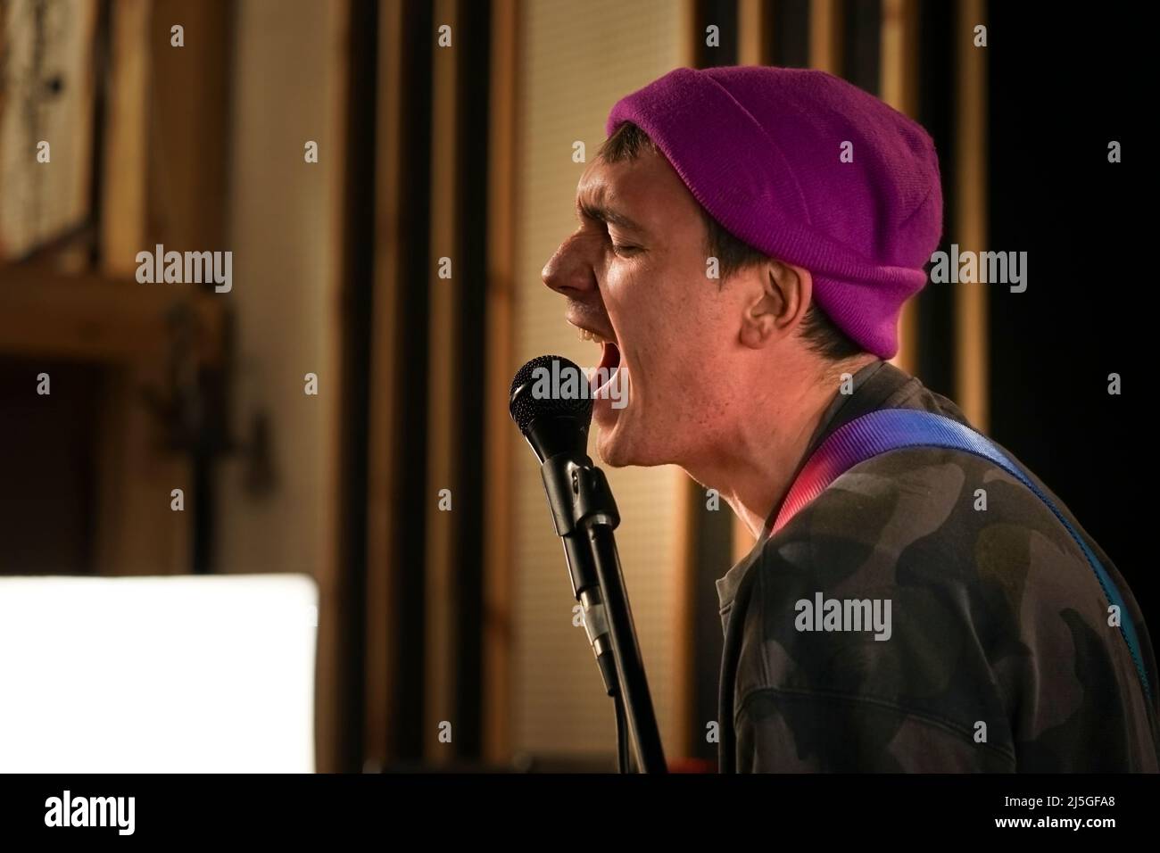 The guy sings into the microphone for voice recording. Portrait of a ...