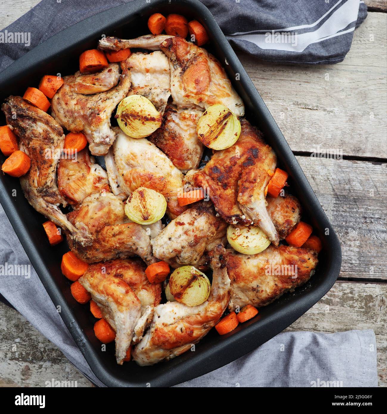 Roasted Hare Haunches in Pan with Stewed Vegetables on Rustic Wooden ...