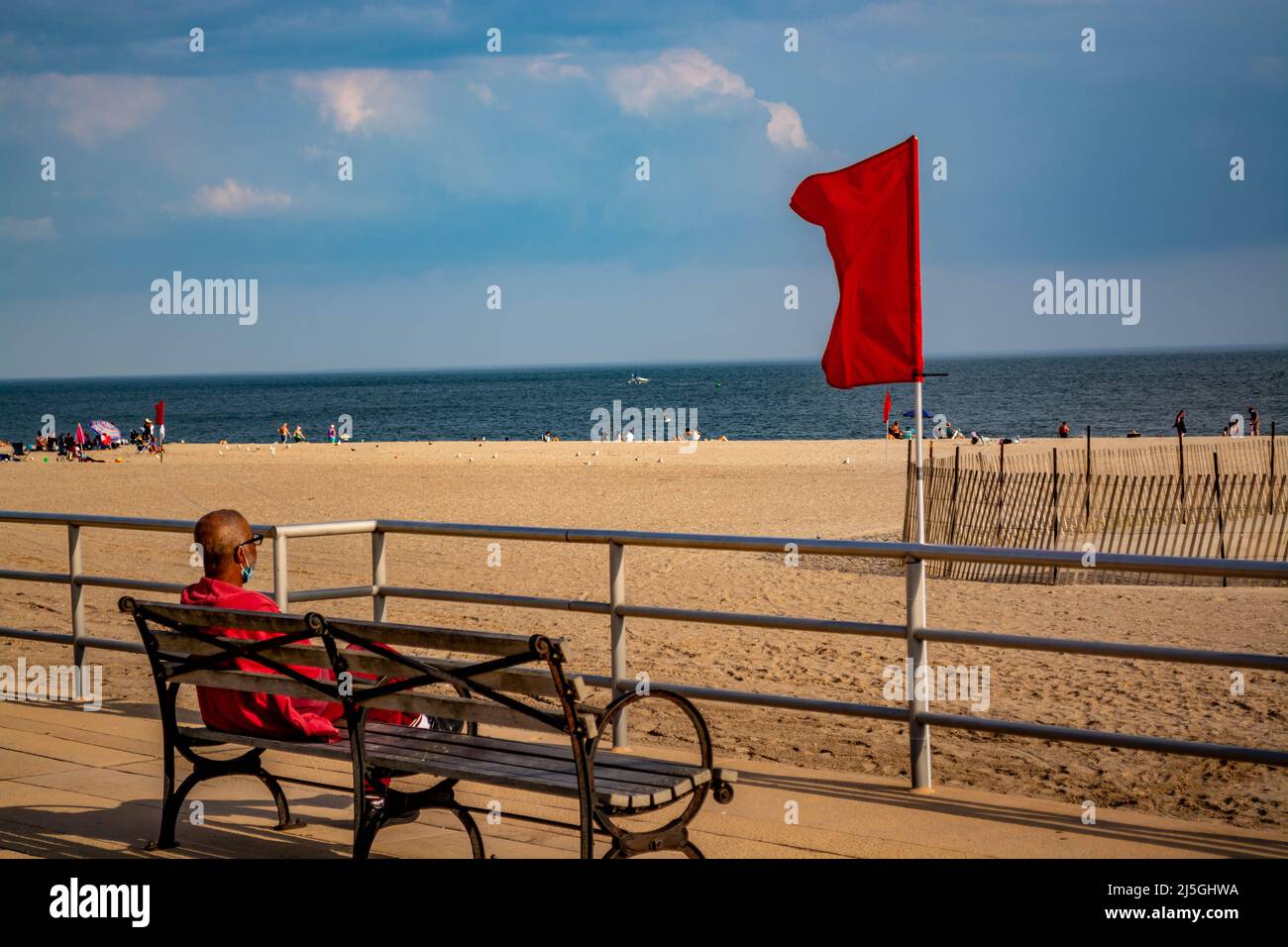 Red flags on the beach indication the beach is closed for swimming ...
