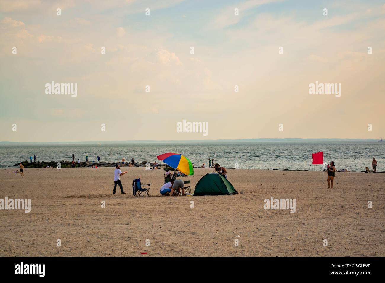 Red flags on the beach indication the beach is closed for swimming ...