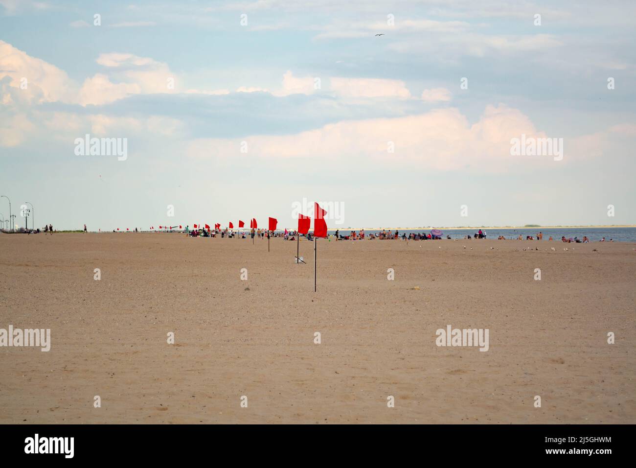 Red flags on the beach indication the beach is closed for swimming ...