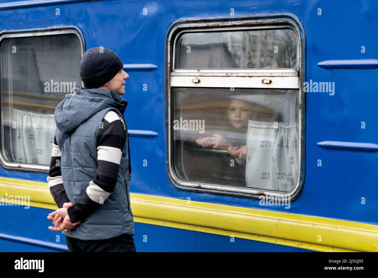 A man stands on the platform as he says bye to his family and friends ...