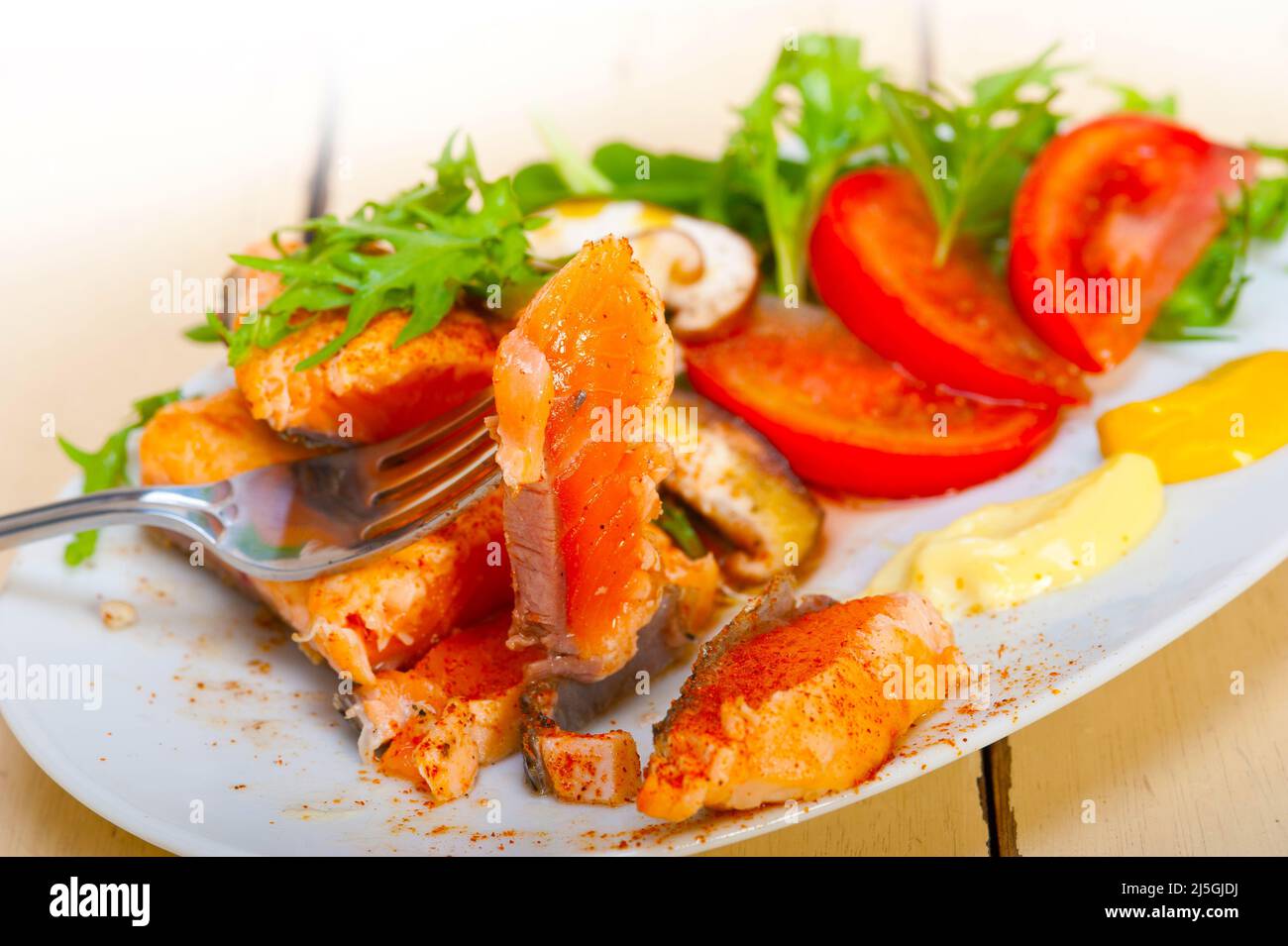 grilled fresh samon filet with vegetables salad tomato arugula ...