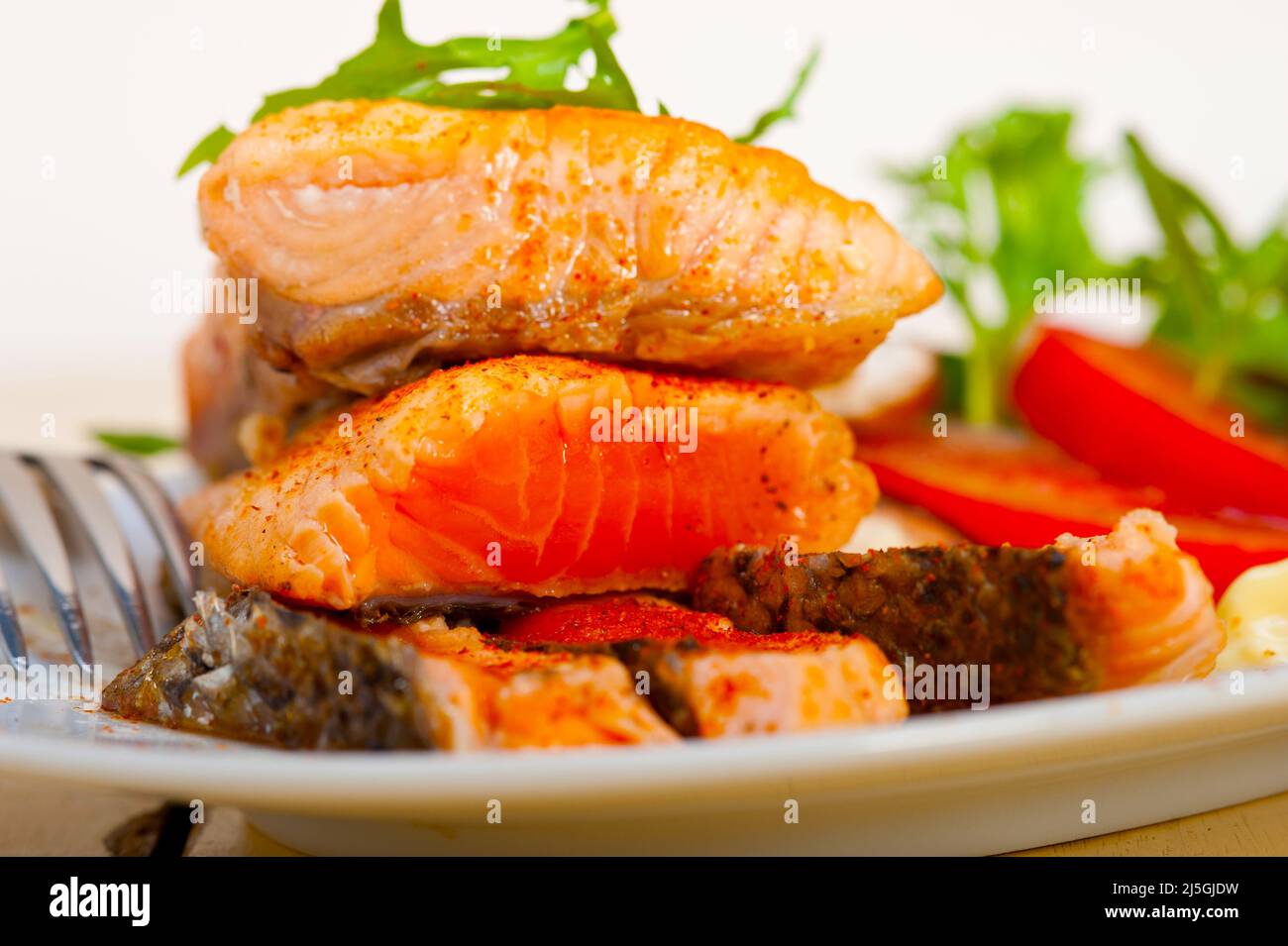 grilled fresh samon filet with vegetables salad tomato arugula ...
