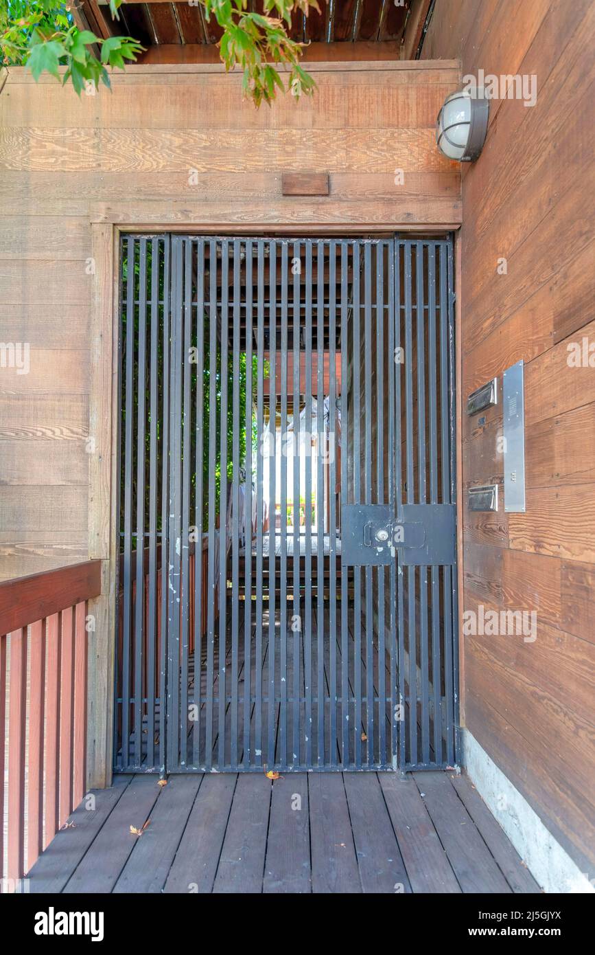 Wrought iron gate with wood planks walls and pathway at San Francisco ...