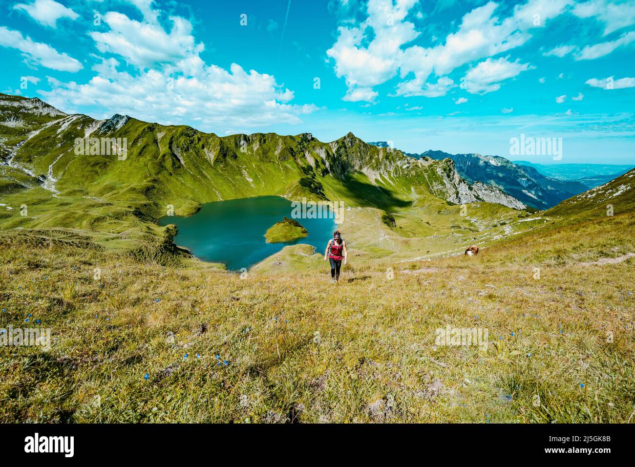 Woman is hiking at lake Schrecksee in the bavarian alps Stock Photo - Alamy