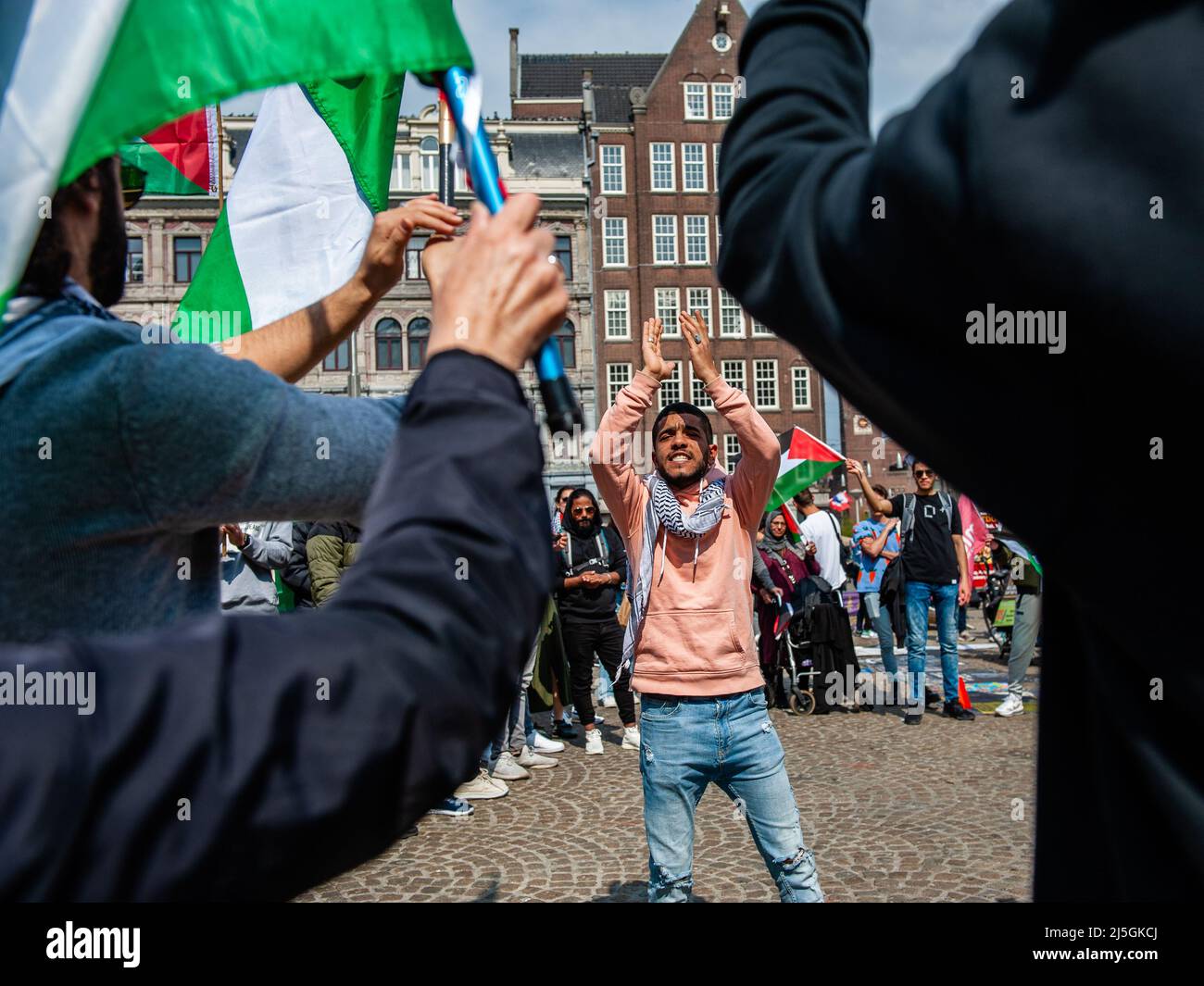 A Palestinian man is seen clapping hands during the demonstration ...