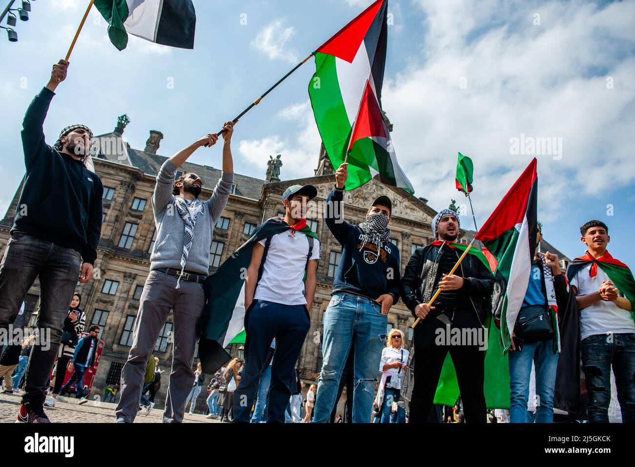 Young Palestinian men wave Palestinian flags during the demonstration ...