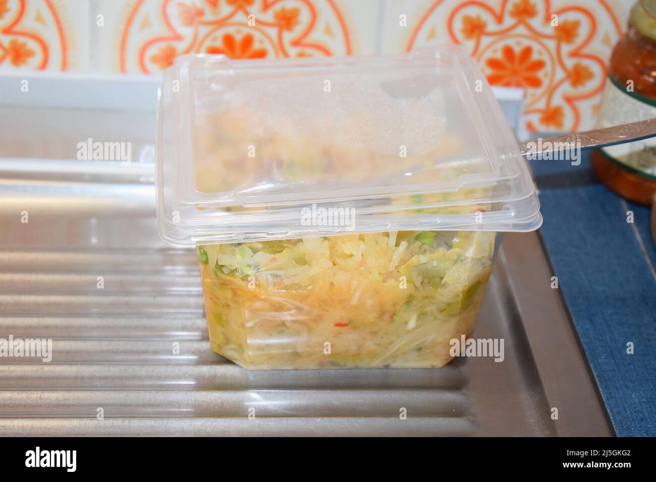 coleslaw in a plastic pot, spiced up Stock Photo - Alamy