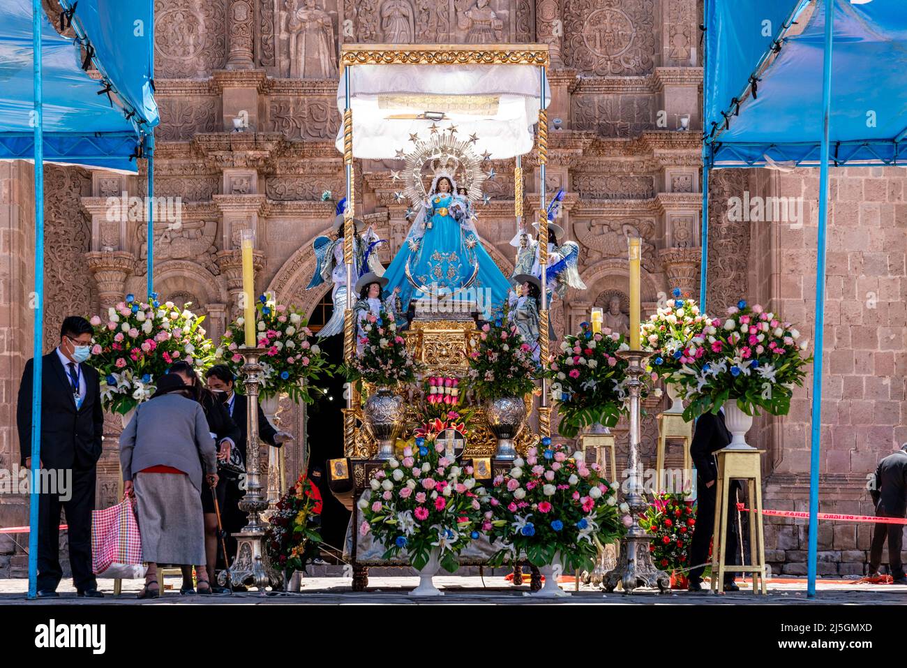 A Statue Of The Virgin Mary Sits On Display Outside Puno Cathedral ...