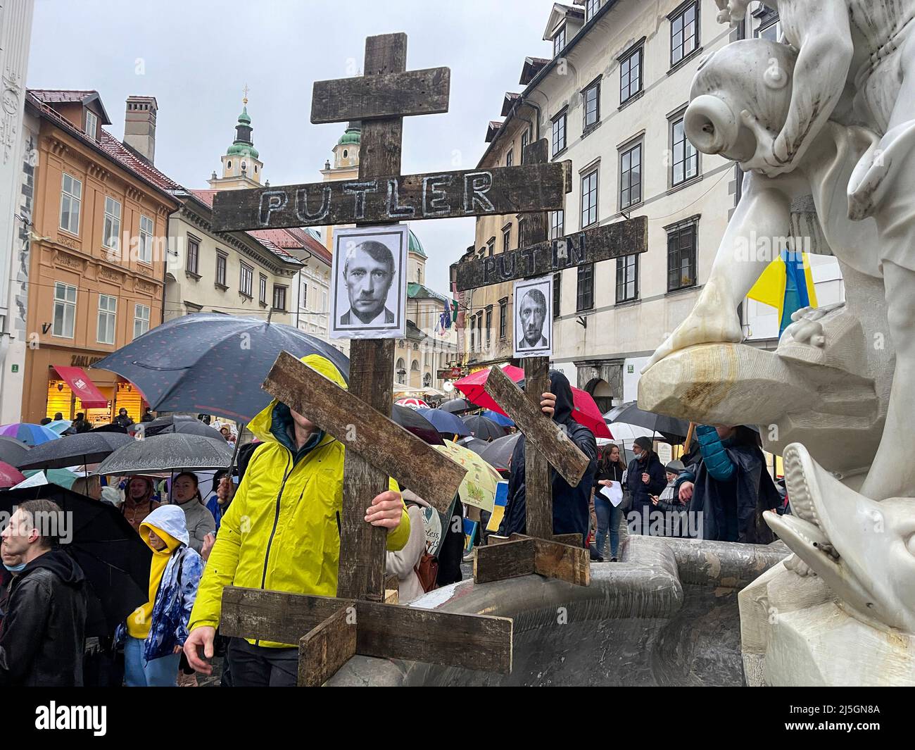 People with Putin's posters on cross of crucifixion and inscription ...