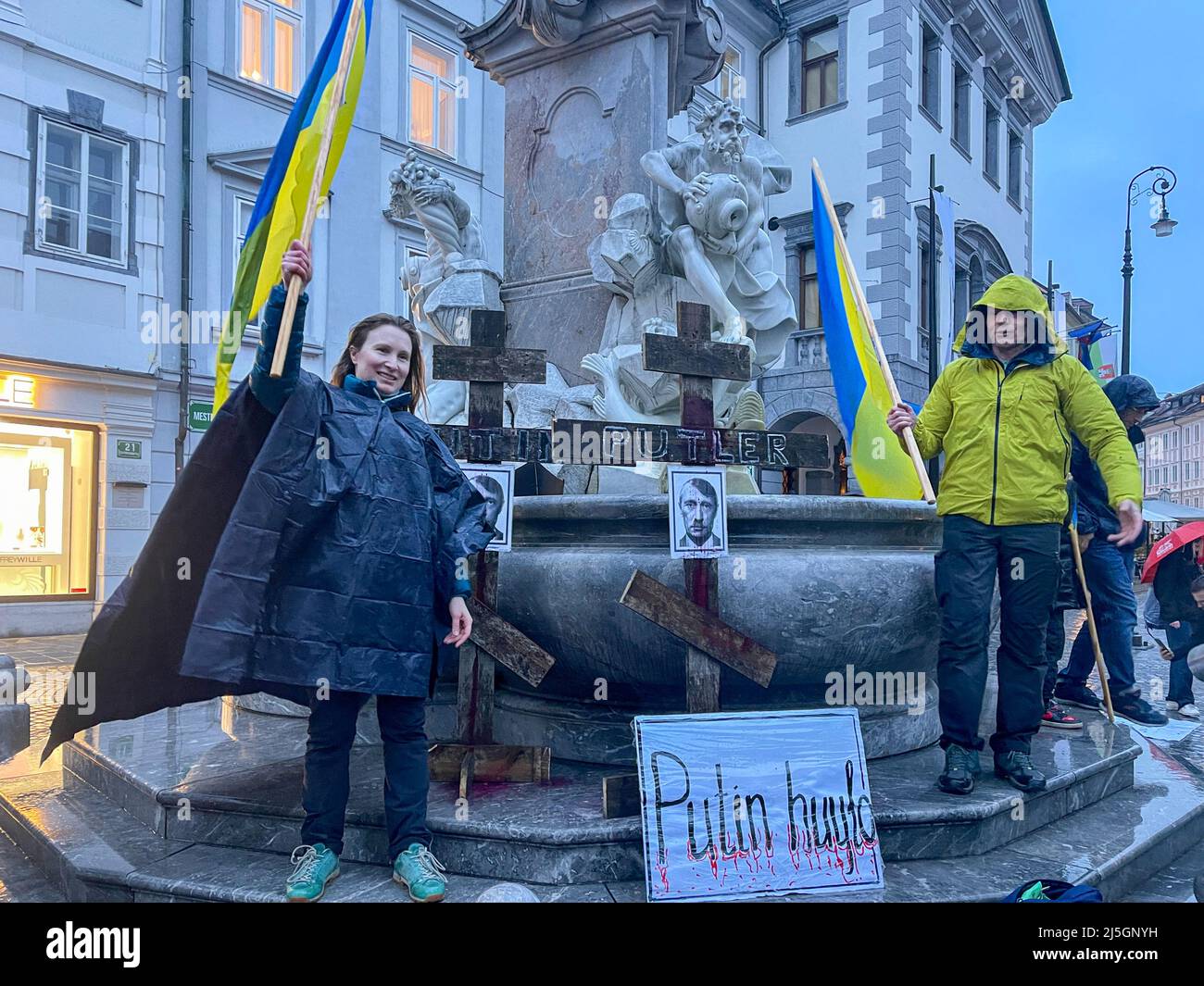 People with Putin's posters on cross of crucifixion and inscription ...