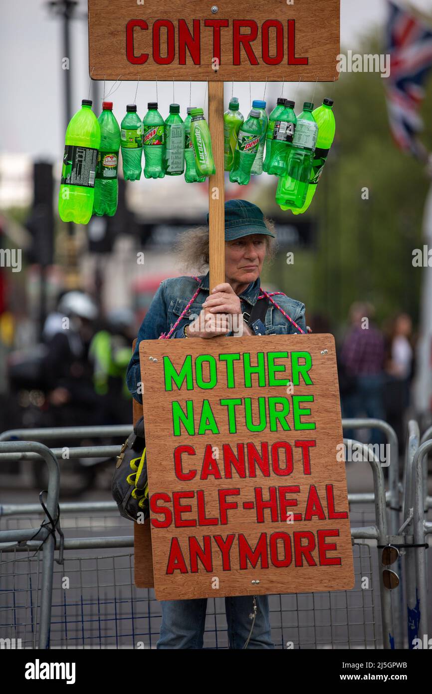 London, UK. 23rd Apr, 2022. A man holding placards with empty bottles ...