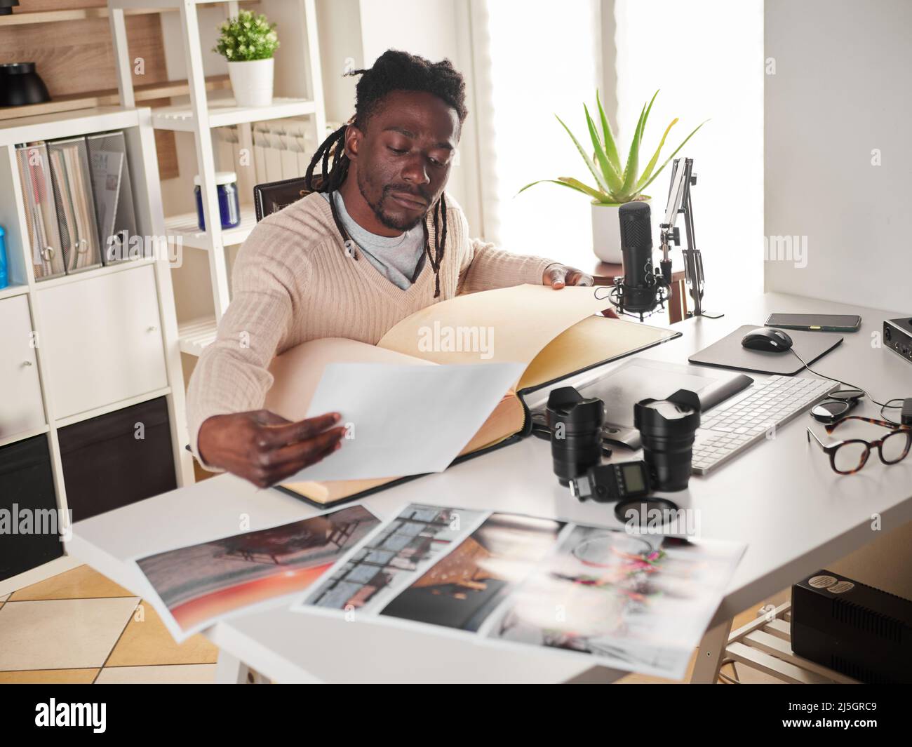 Graphic designer/photographer working in home office Stock Photo - Alamy