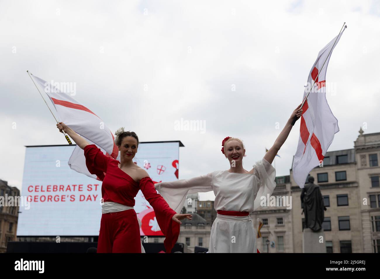Two actresses dressed in white and red wave St George’s flags at ...