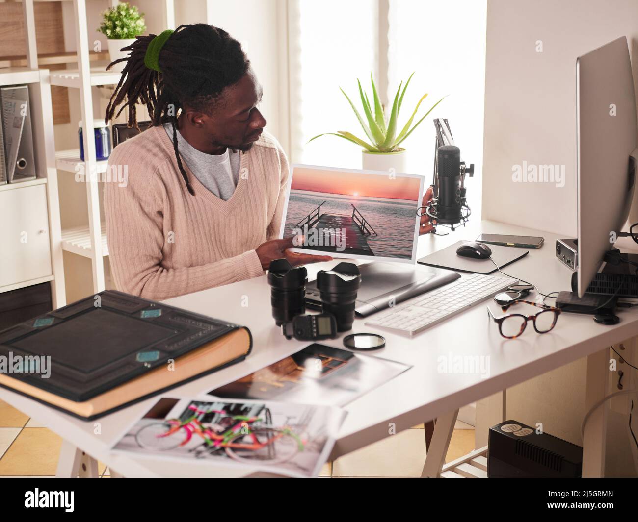 Graphic designer/photographer working in home office Stock Photo - Alamy