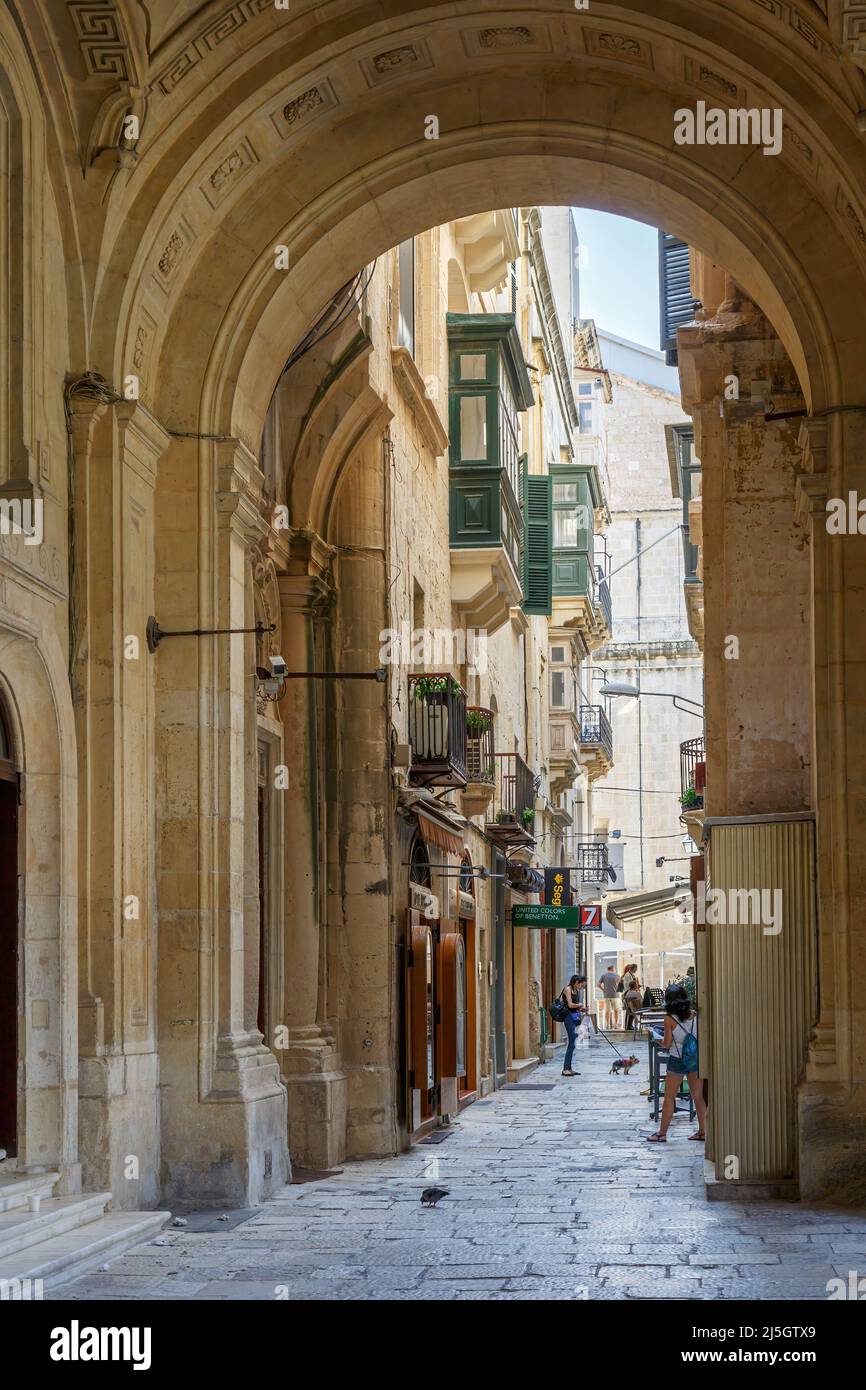 A view between the stonework arches of Merchants Street, Valletta ...