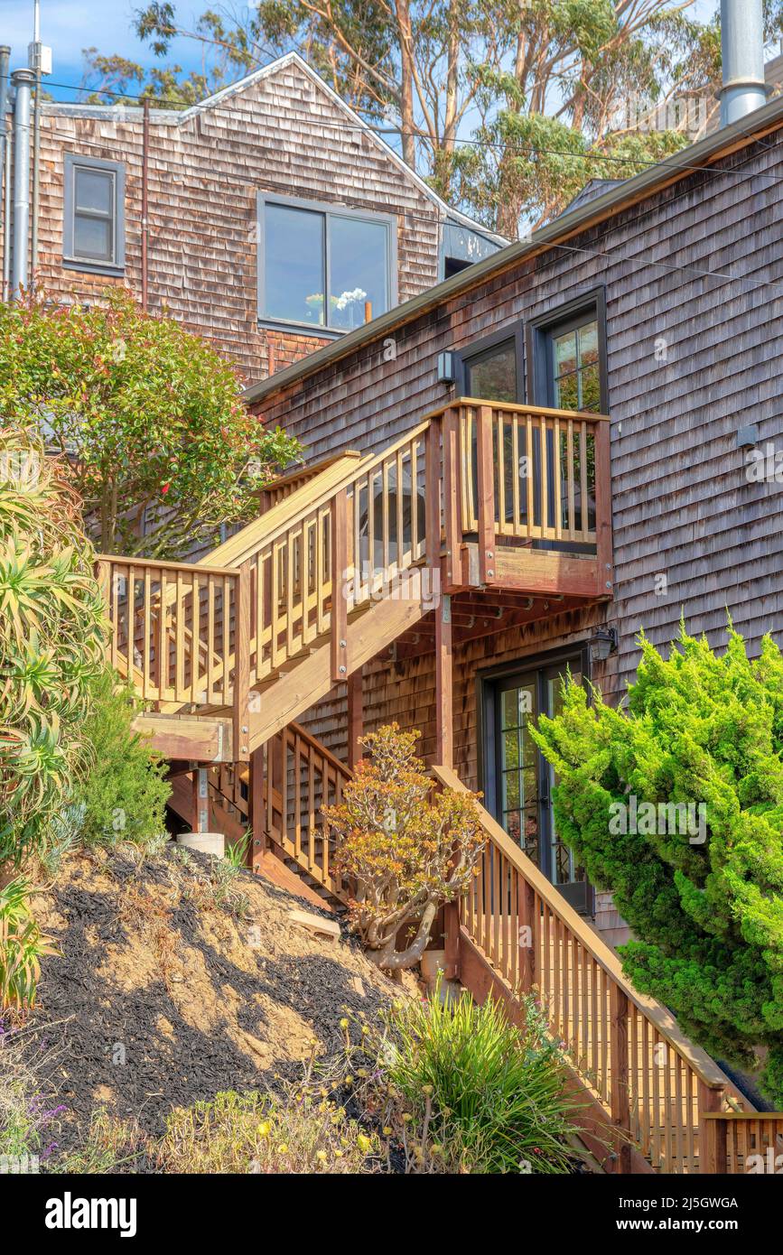 Wooden staircase of a house with landing on top of a slope at San ...