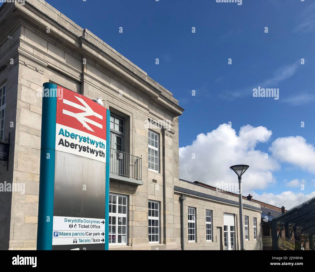Aberystwyth train station sign and building Stock Photo - Alamy