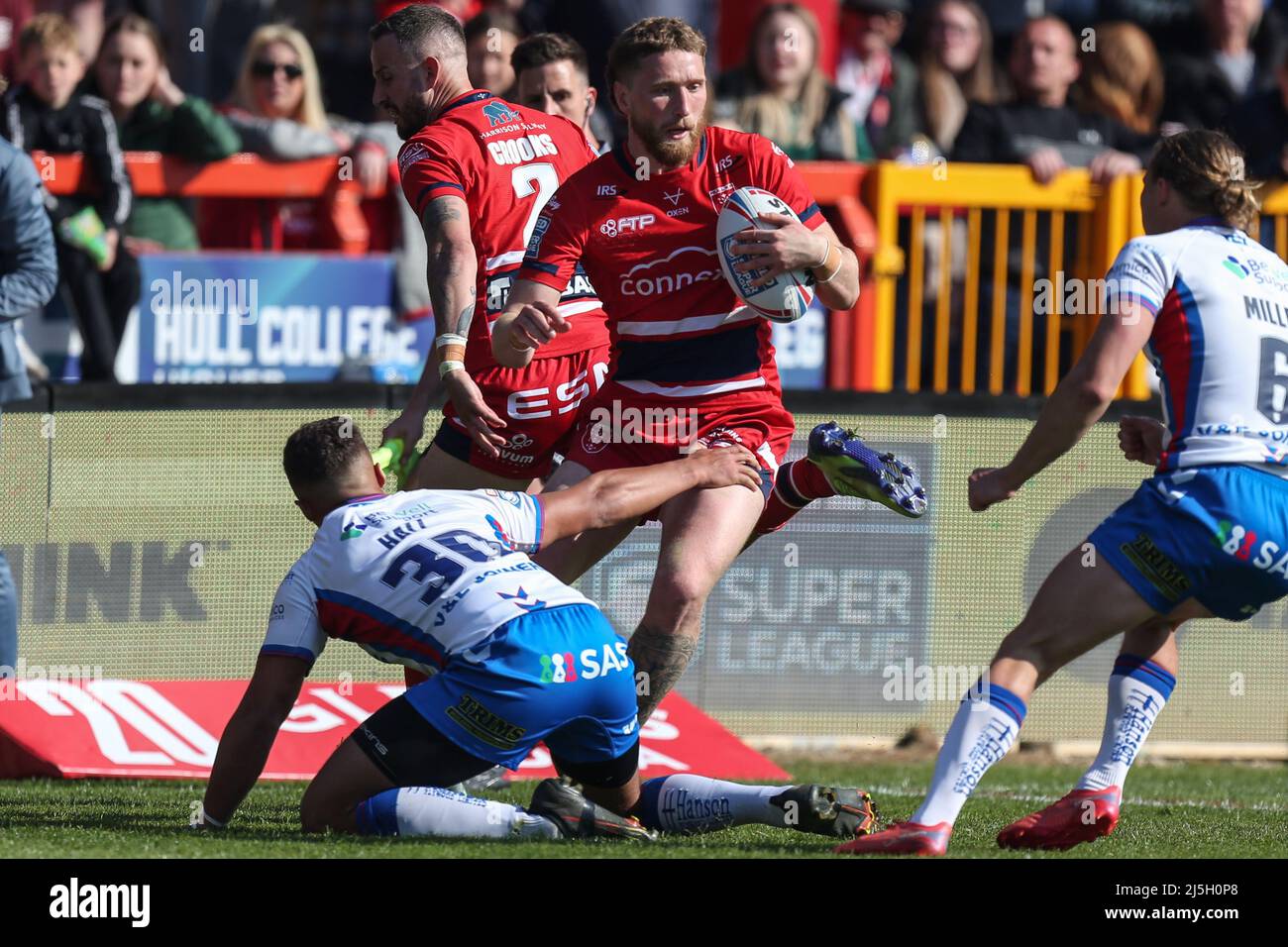 Ethan Ryan #23 of Hull KR looks to past Corey Hall #30 of Wakefield ...