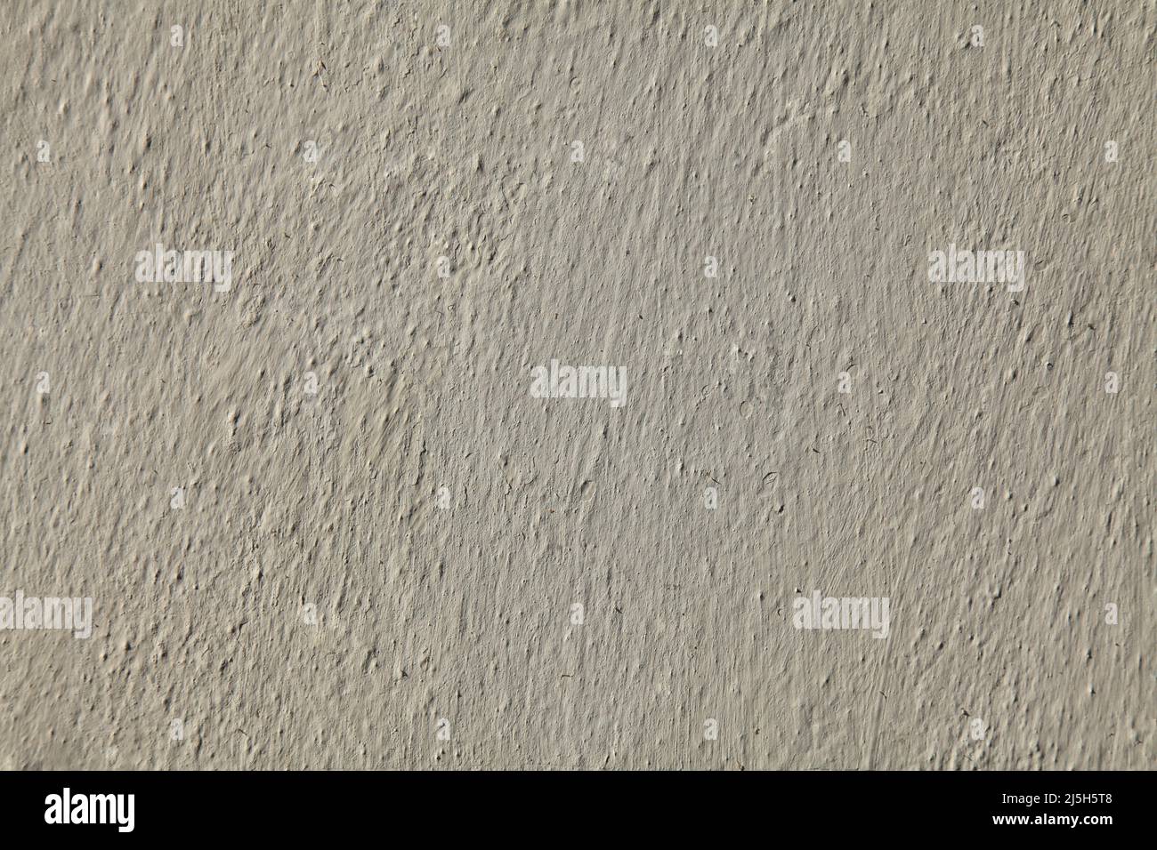 White and uneven wall painted with whitening, texture, background. An ...