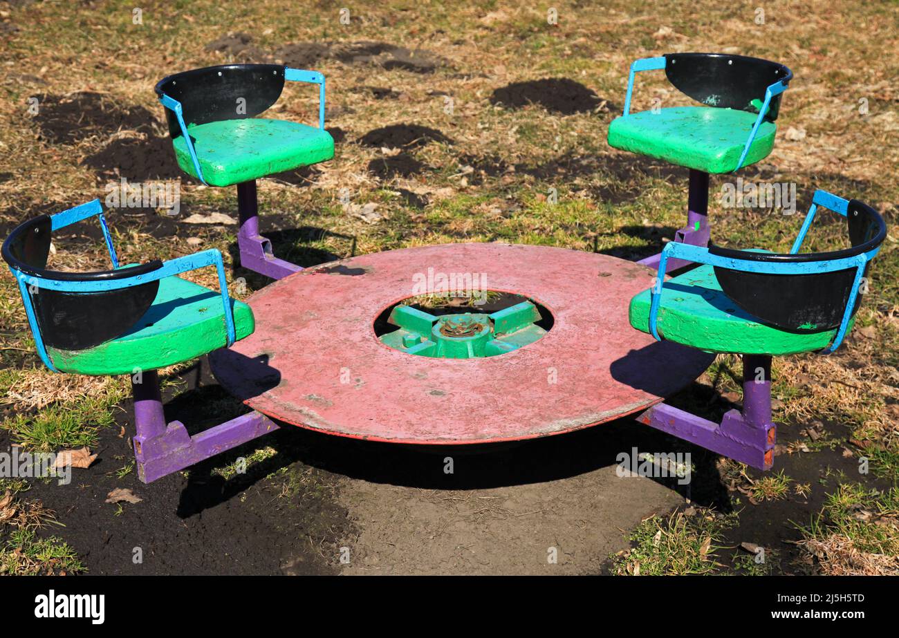Old rusty disc children's carousel. Desert city and playground with ...