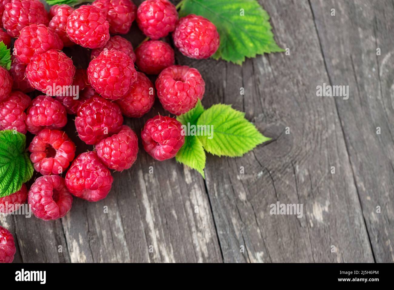 Sweet fresh raspberry on wood background Stock Photo - Alamy