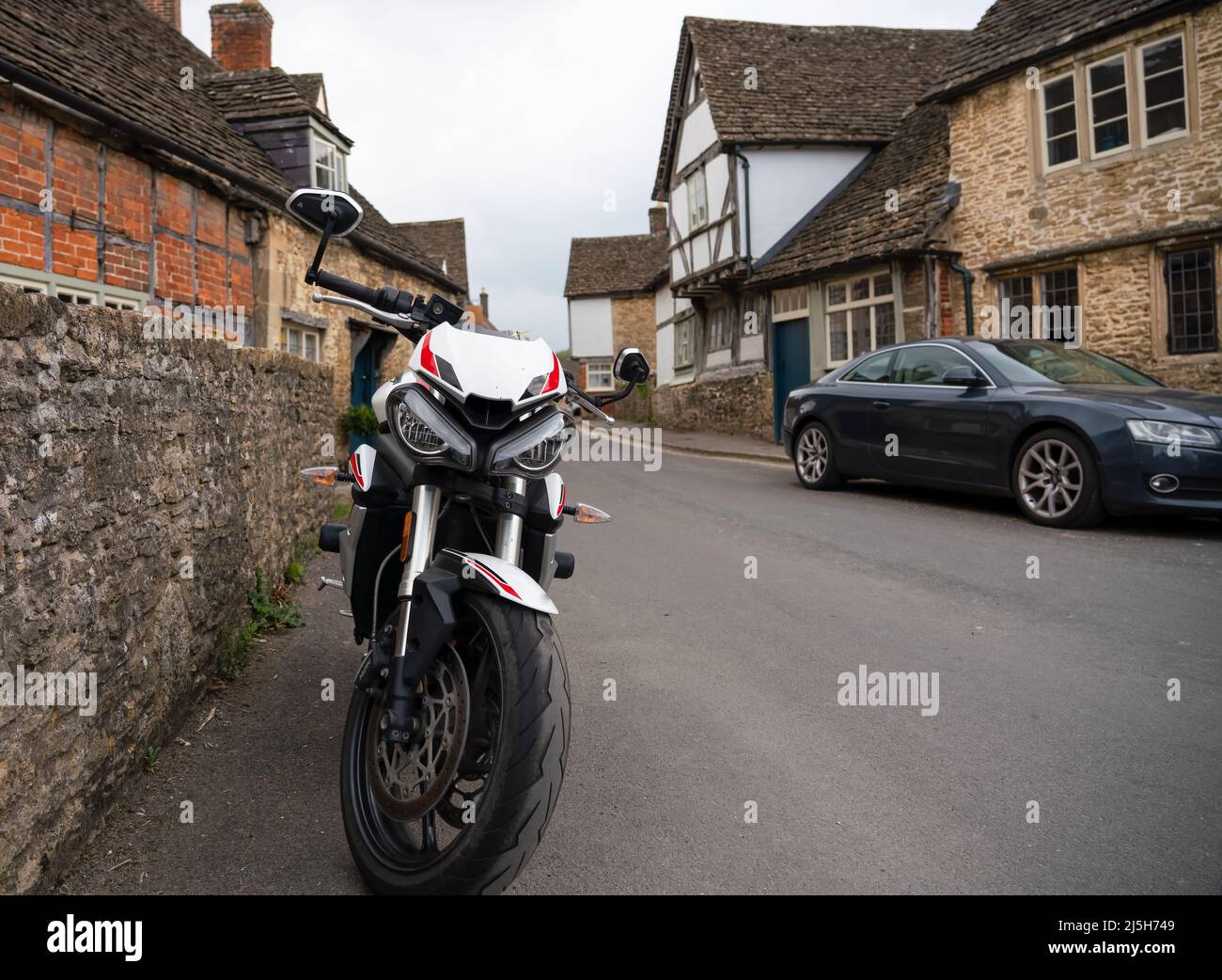white triumph street triple S motorcycle parked in an 18th Century ...