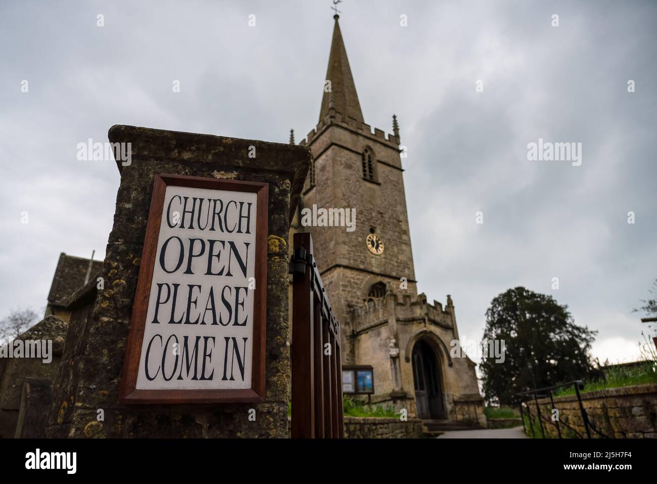 welcome sign by path leading up to the front of 14th Century St Cyriac ...