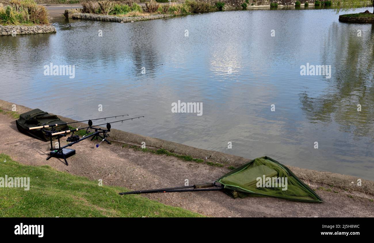 Fishing rods and net at the Winterbourne village Duck Pond, Bristol, UK ...
