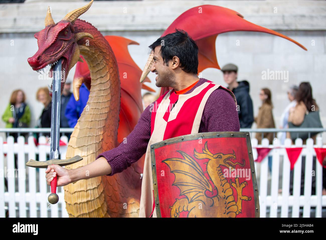 A performer dressed as a knight is seen slaying a model dragon at Saint ...