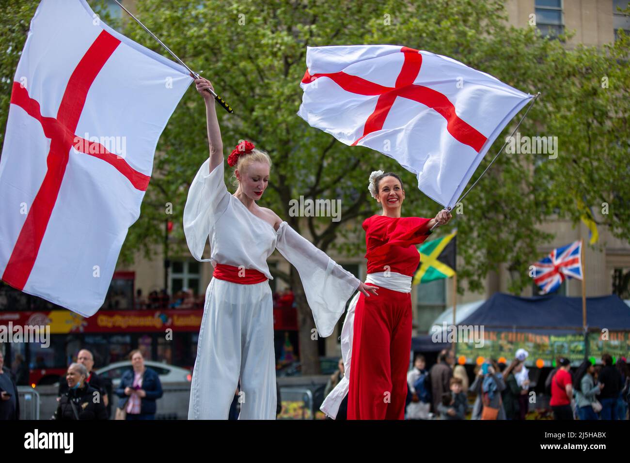 Entertainers on stilts hold English flags at the Saint George's ...