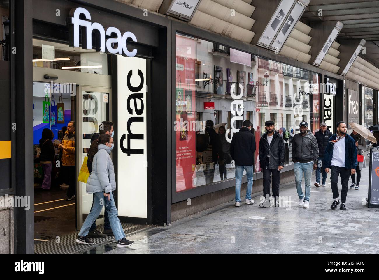 Pedestrians walk past the French electronics and cultural multinational ...