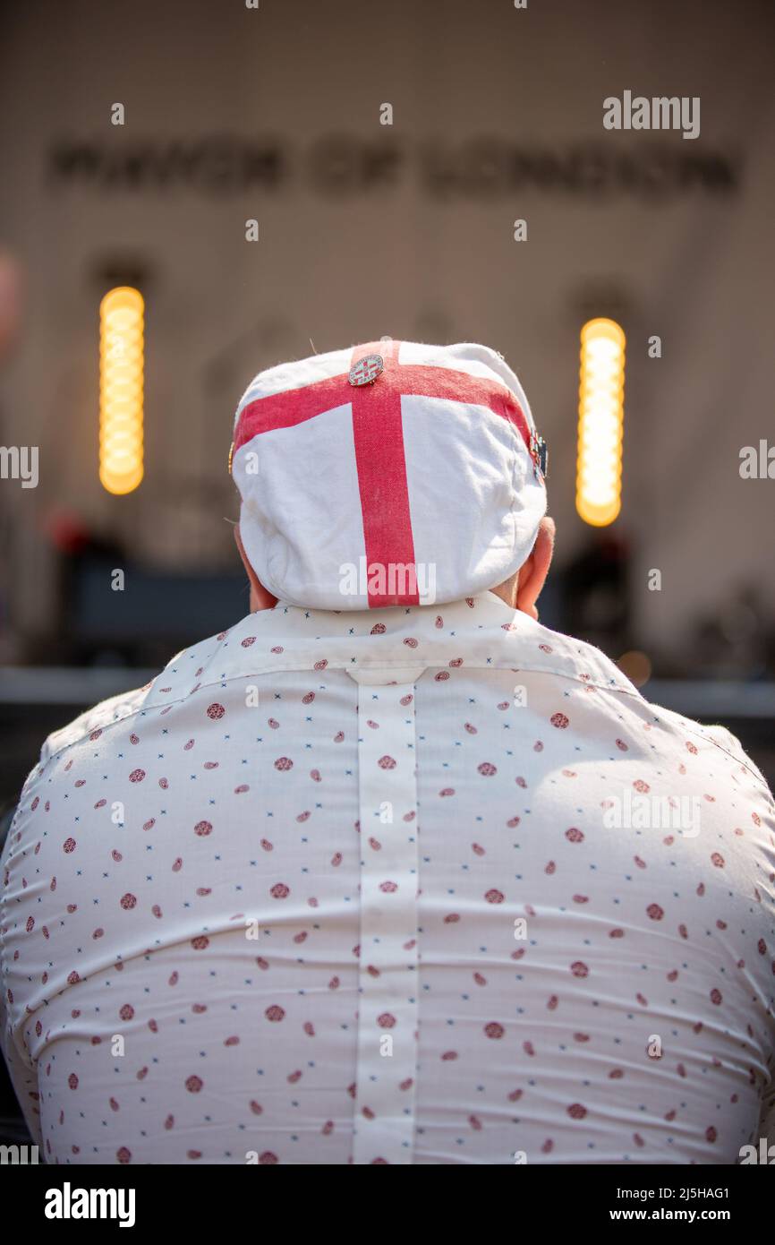 London, UK. 23rd Apr, 2022. A man wearing an England flat cap watches ...