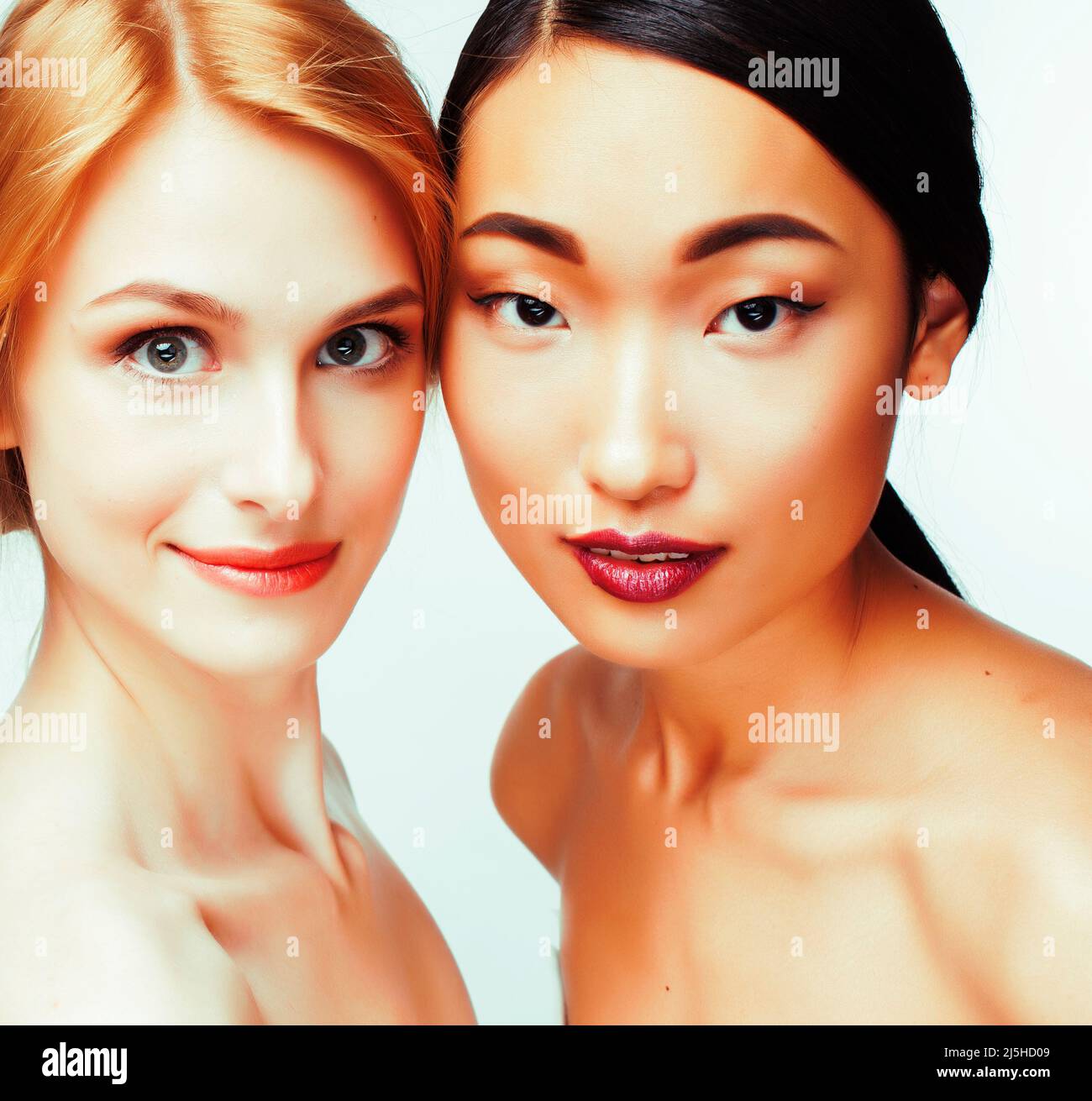 different nation woman: caucasian and asian together isolated on white ...