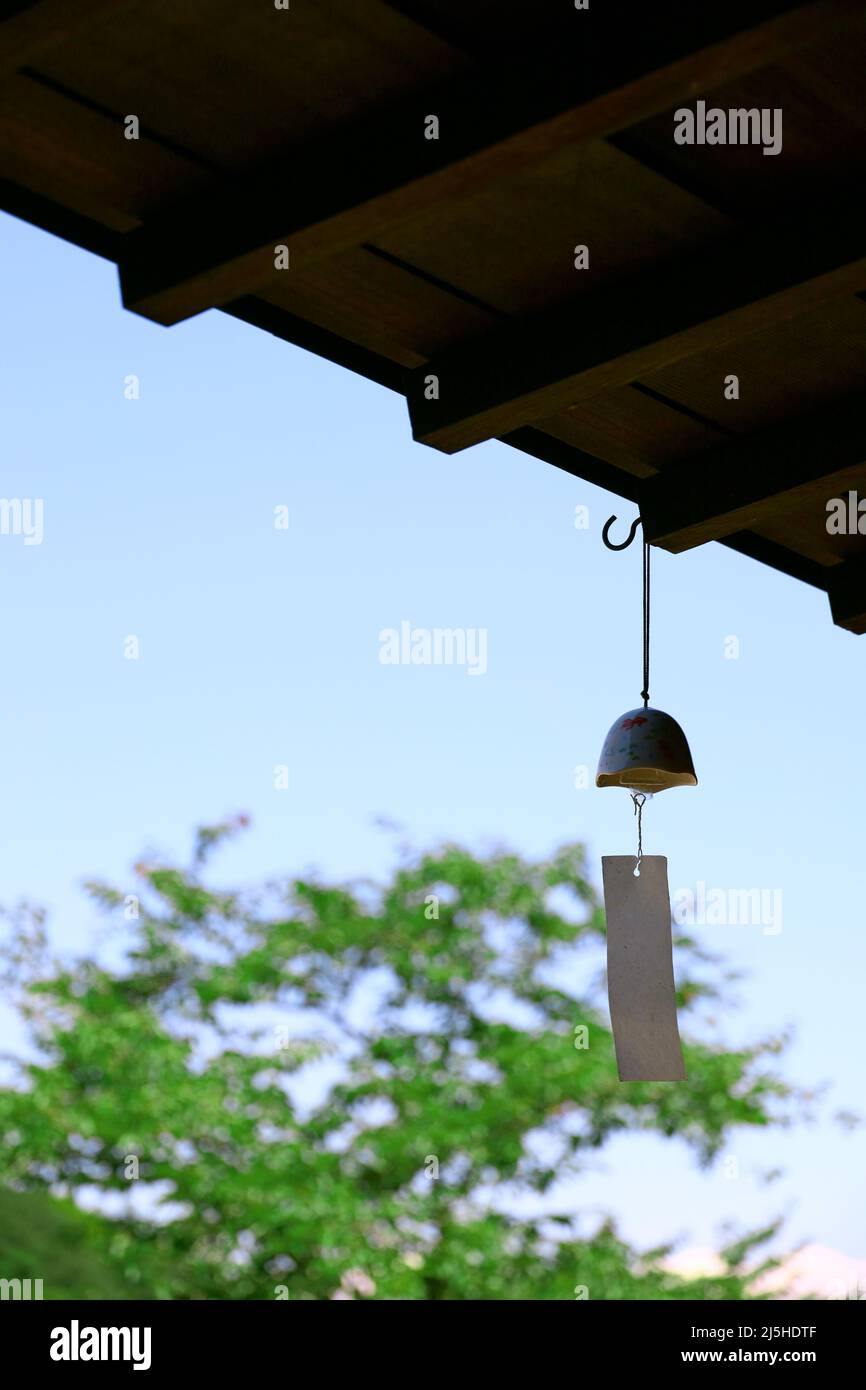 The eaves of a shop where a wind chime called "Furin", a Japanese ...