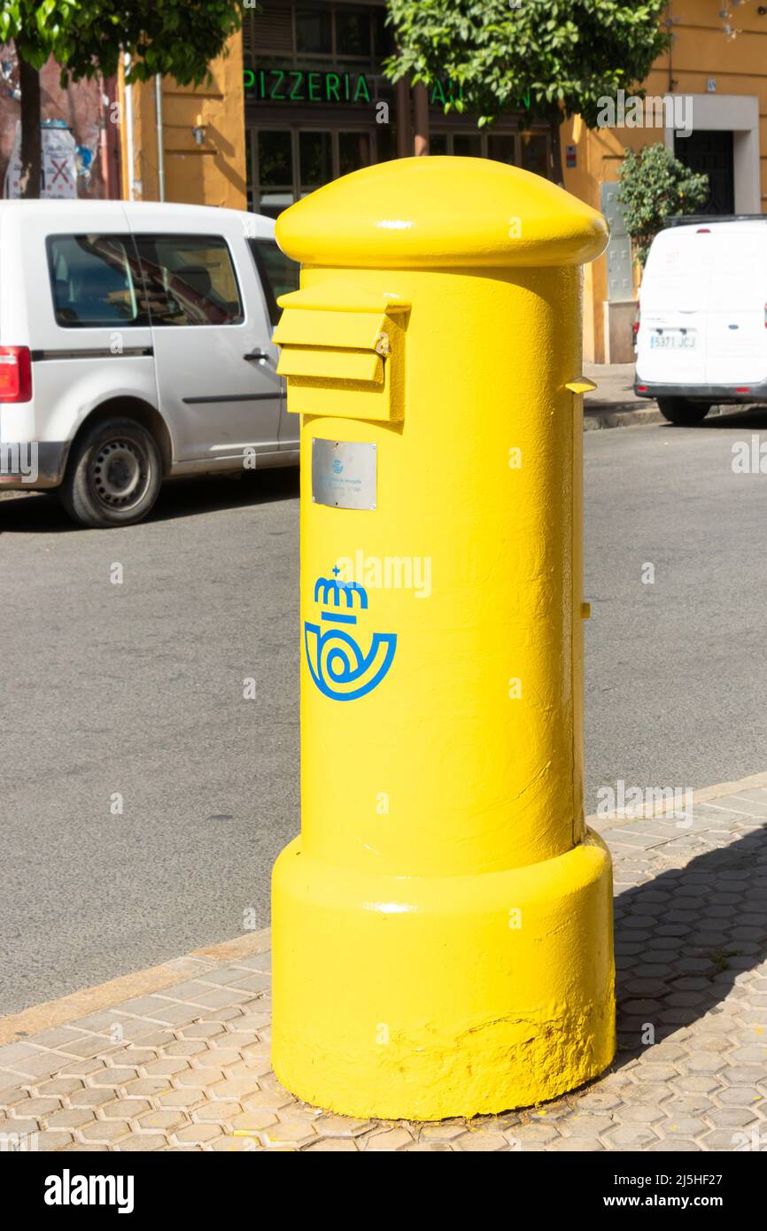 Yellow Correos post office postbox in street in Seville spain Stock ...